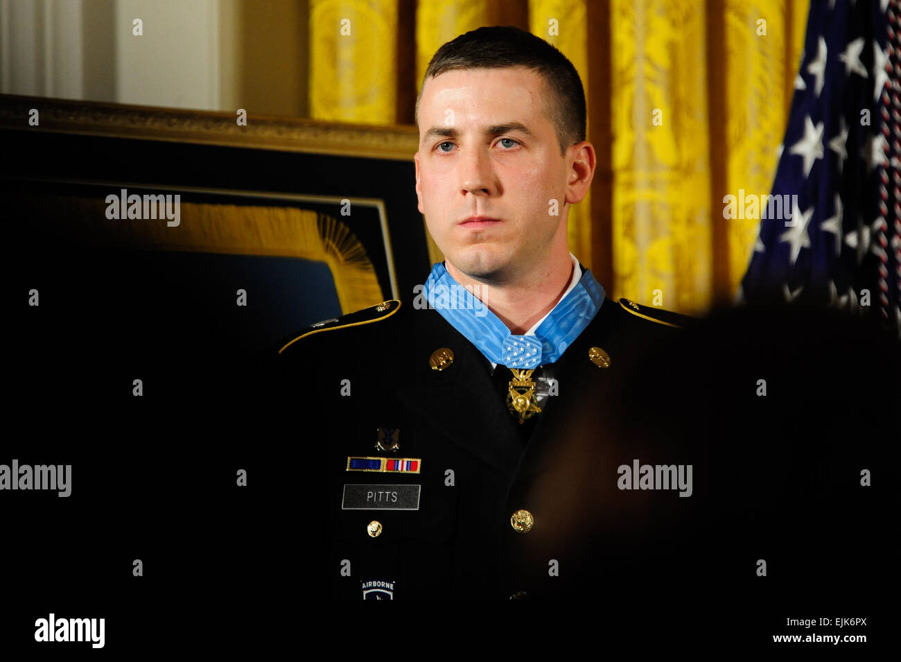 Former U.S. Army Staff Sgt. Ryan M. Pitts stands as the audience ...