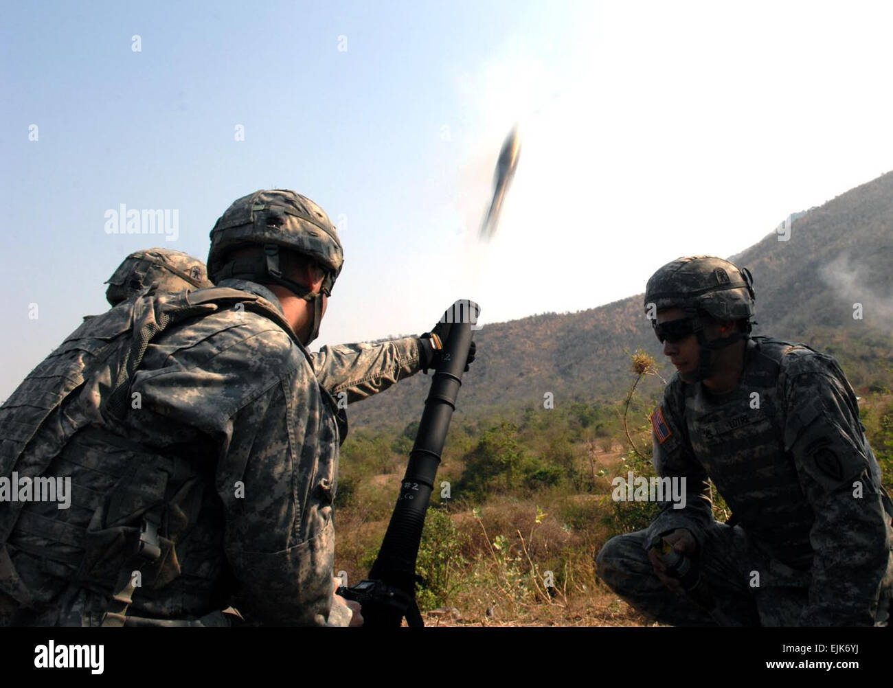 A 60 mm high-explosive round fires from the tube of an M-224 Company ...