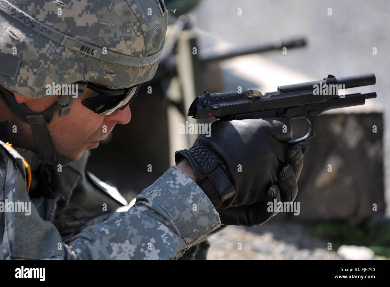 First Lt. Lyndon Hill, assigned to 30th Medical Command, fires the M9 ...