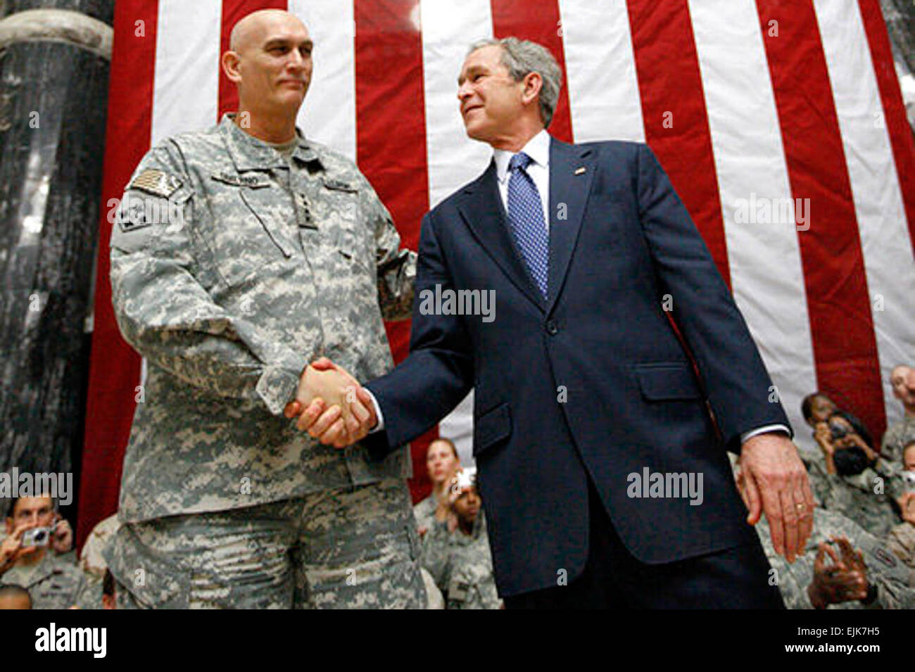 President George W. Bush stands on stage with U.S. Army Gen. Ray ...