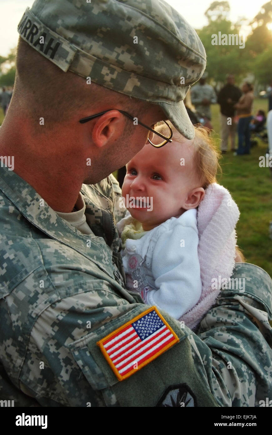 U.S. Army Spc. Adam Darrah holds his daughter Sept. 6, 2007, after ...
