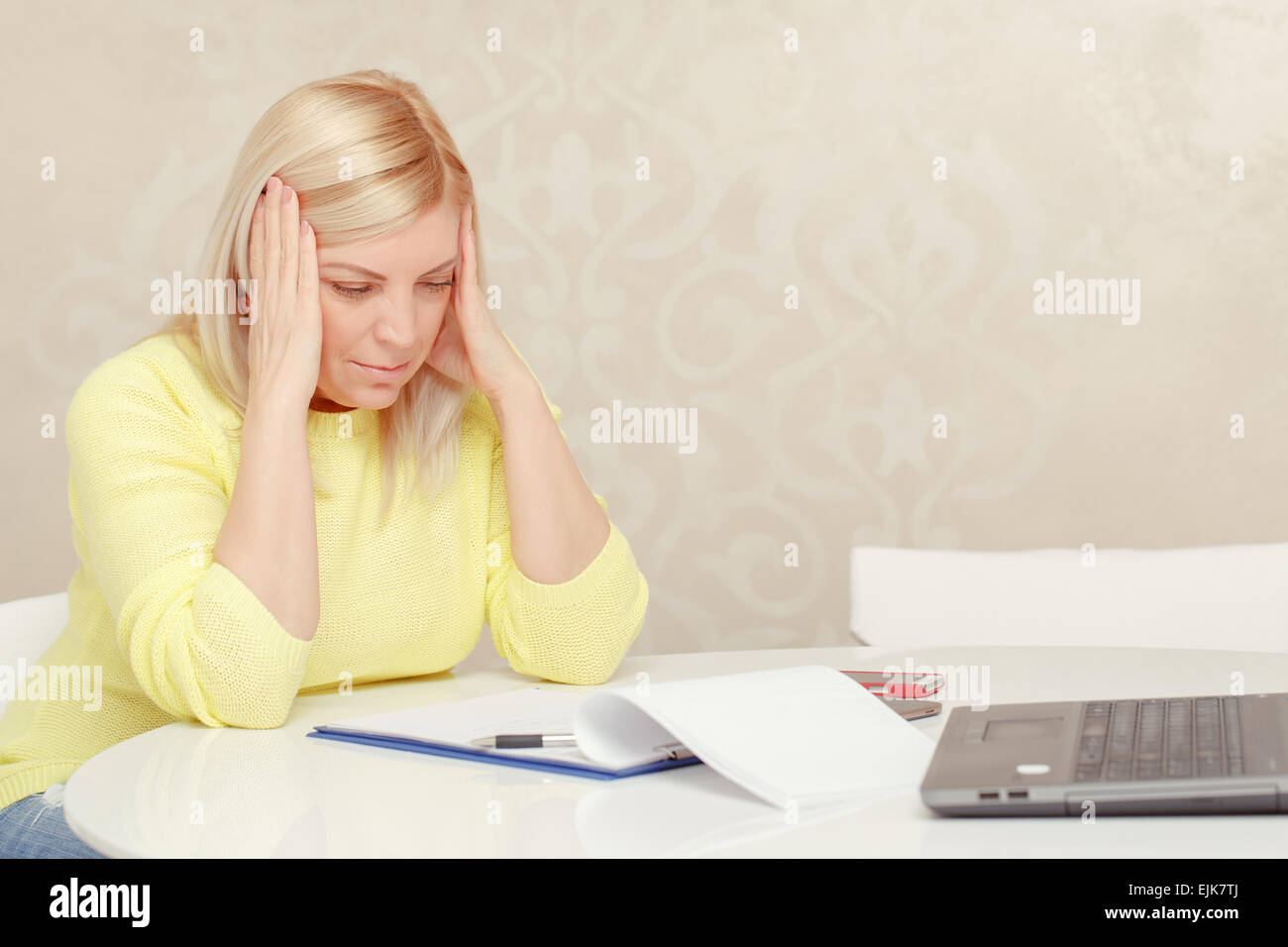 Woman works with papers at home Stock Photo - Alamy