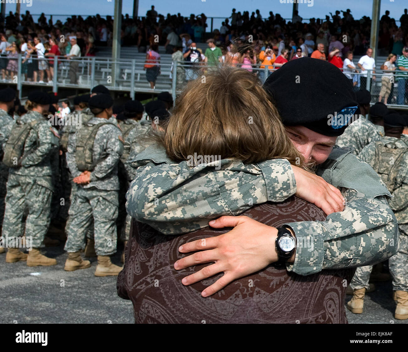 A new Soldier hugs her mother at the conclusion of the basic training ...