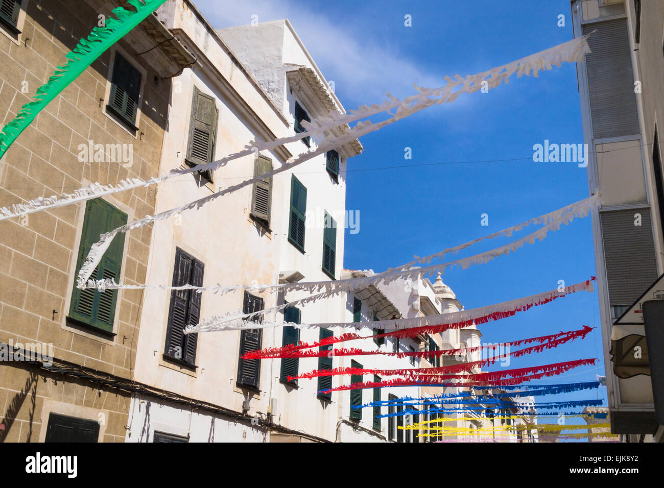 Colourful festive ribbons line the street in the old town of Mahon, the ...
