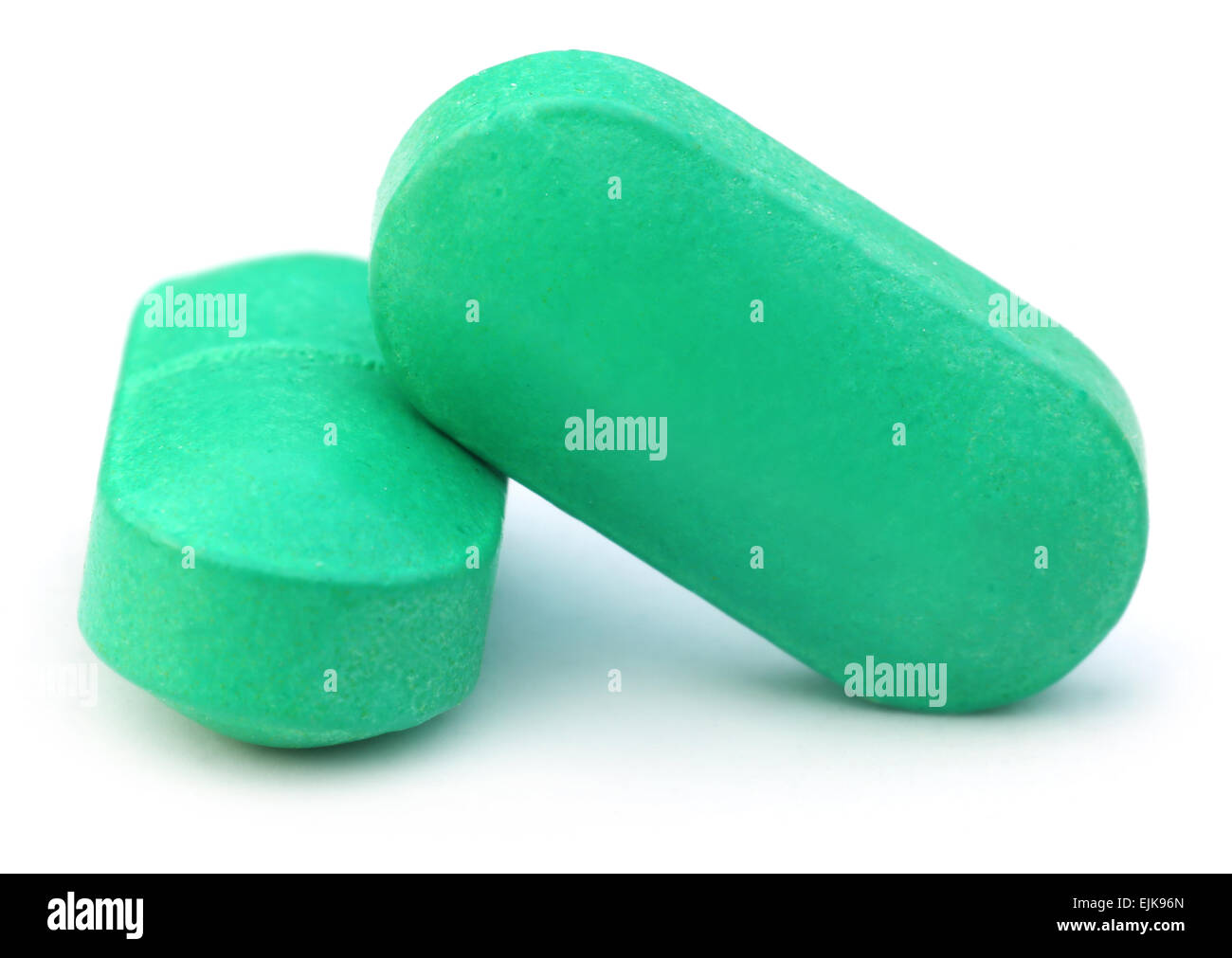 Two green tablets over white background Stock Photo - Alamy