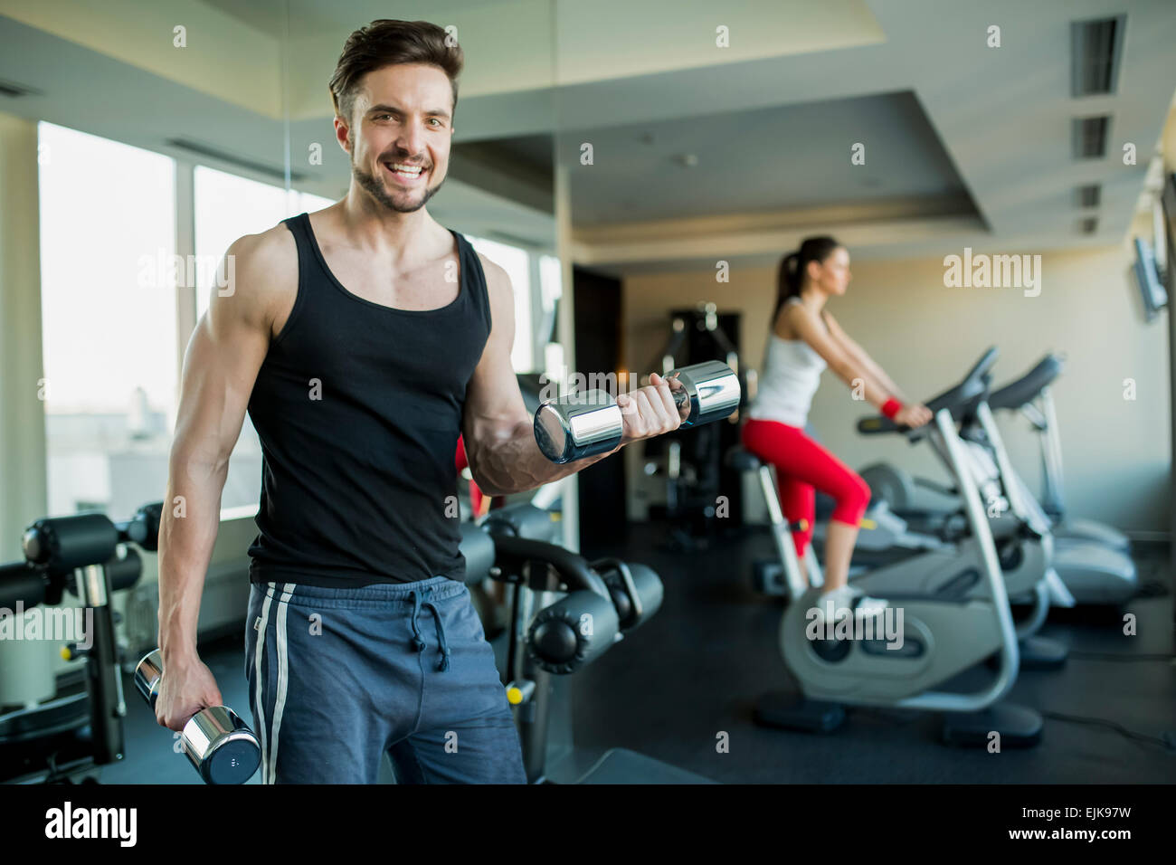 Young man training in the gym Stock Photo - Alamy