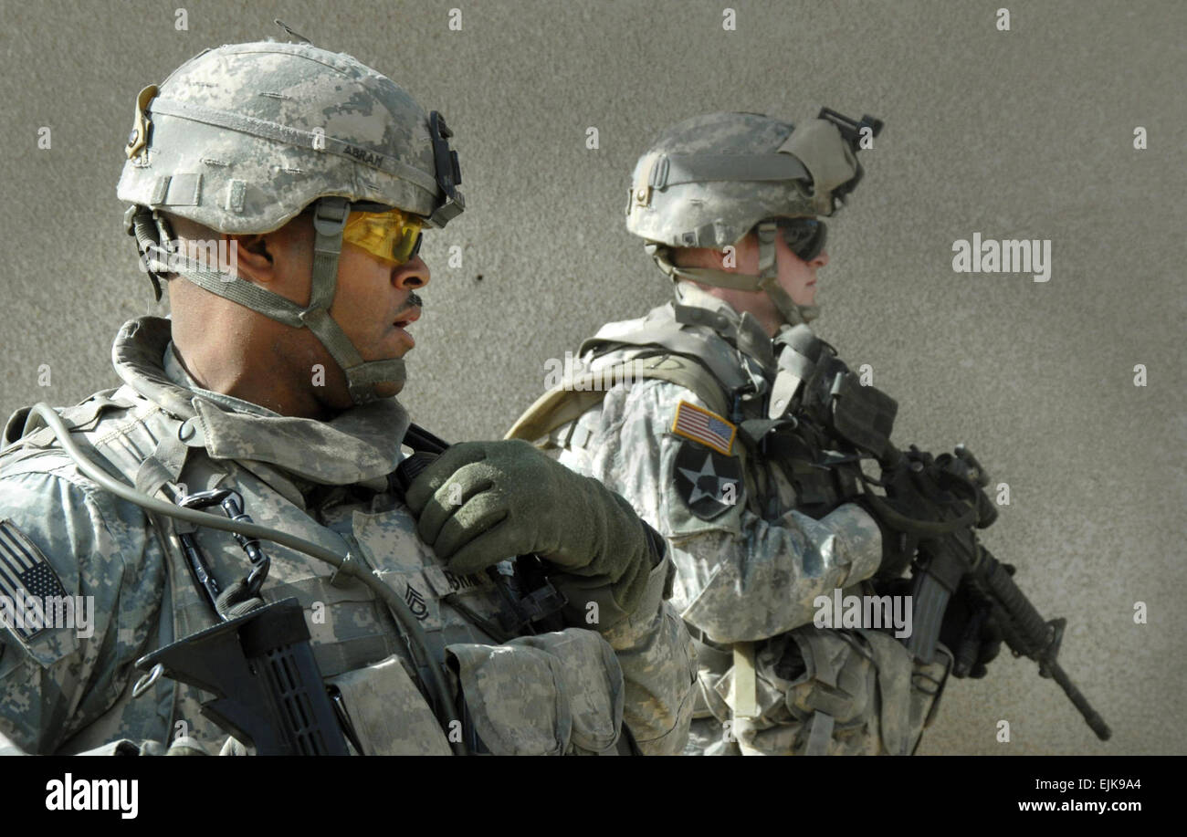 U.S. Army Sgt. 1st Class Robert Abram, left, answers his radio while ...