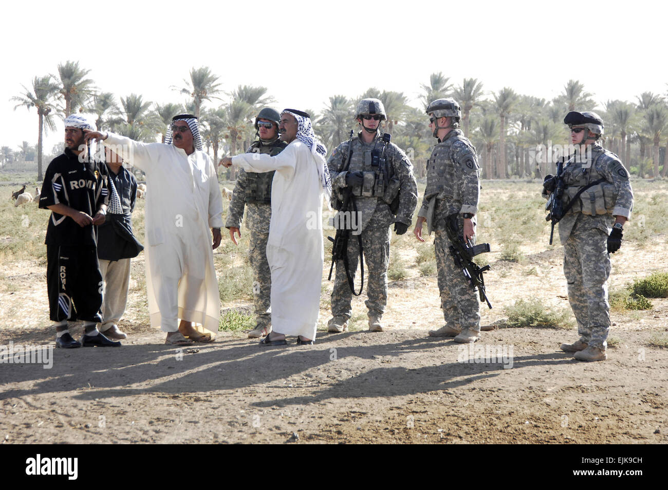 Members of an Iraqi Concerned Citizens group discuss a checkpoint with ...