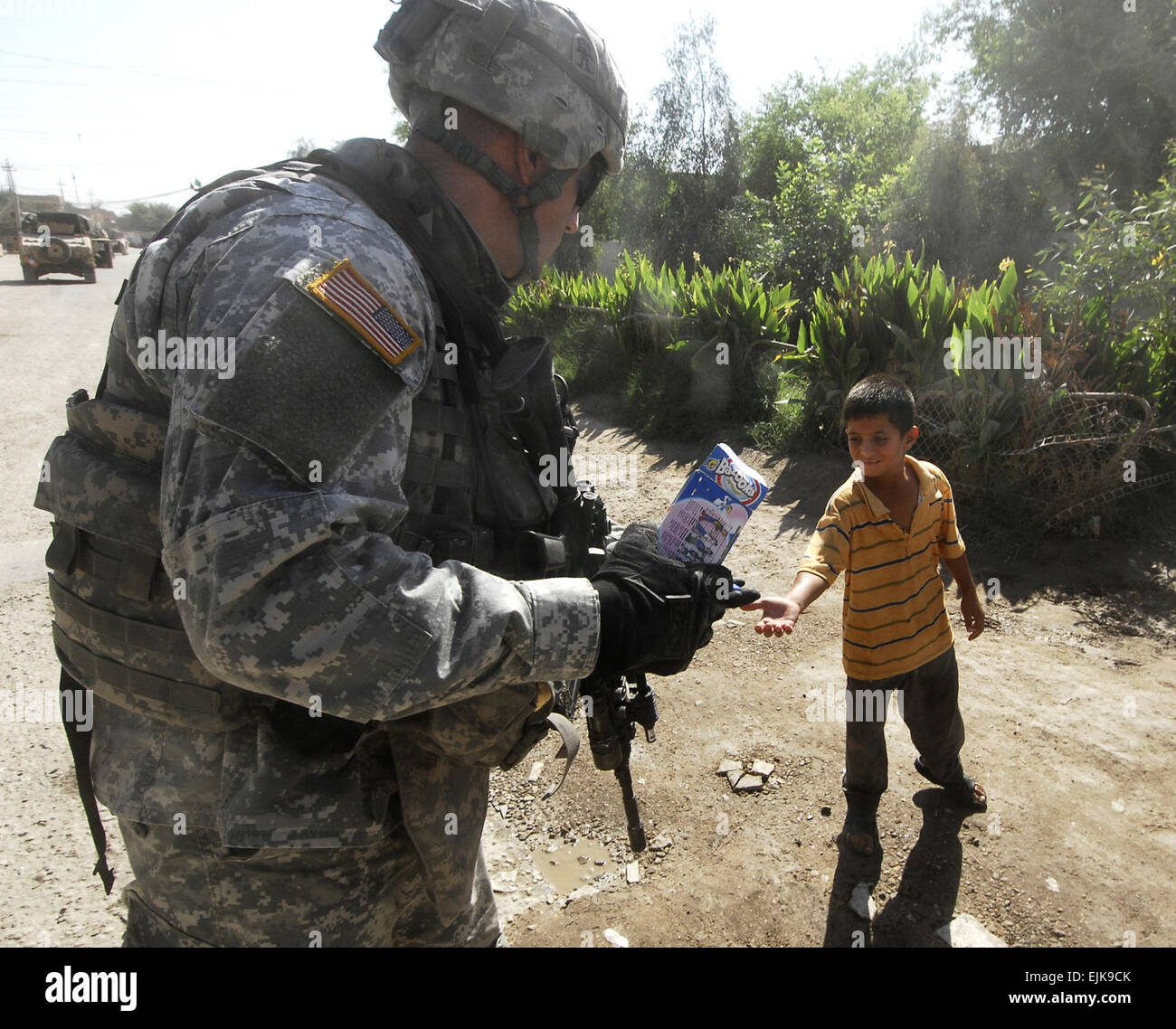 A U.S. Army Soldier gives an Iraqi child candy while on patrol in Haswa ...