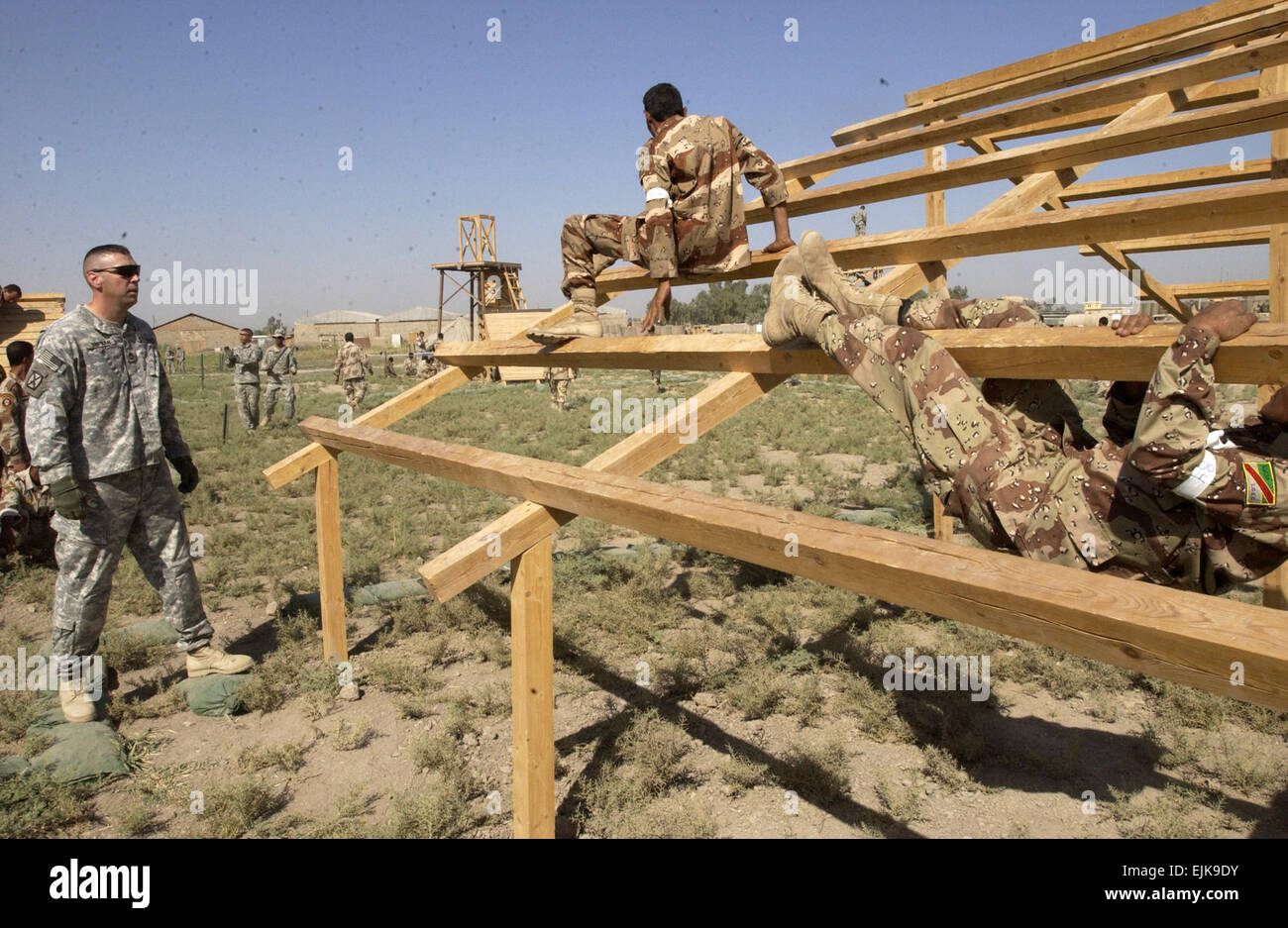 U.S. Army Sfc. Carl Shipman watches as Iraqi army soldiers maneuver ...