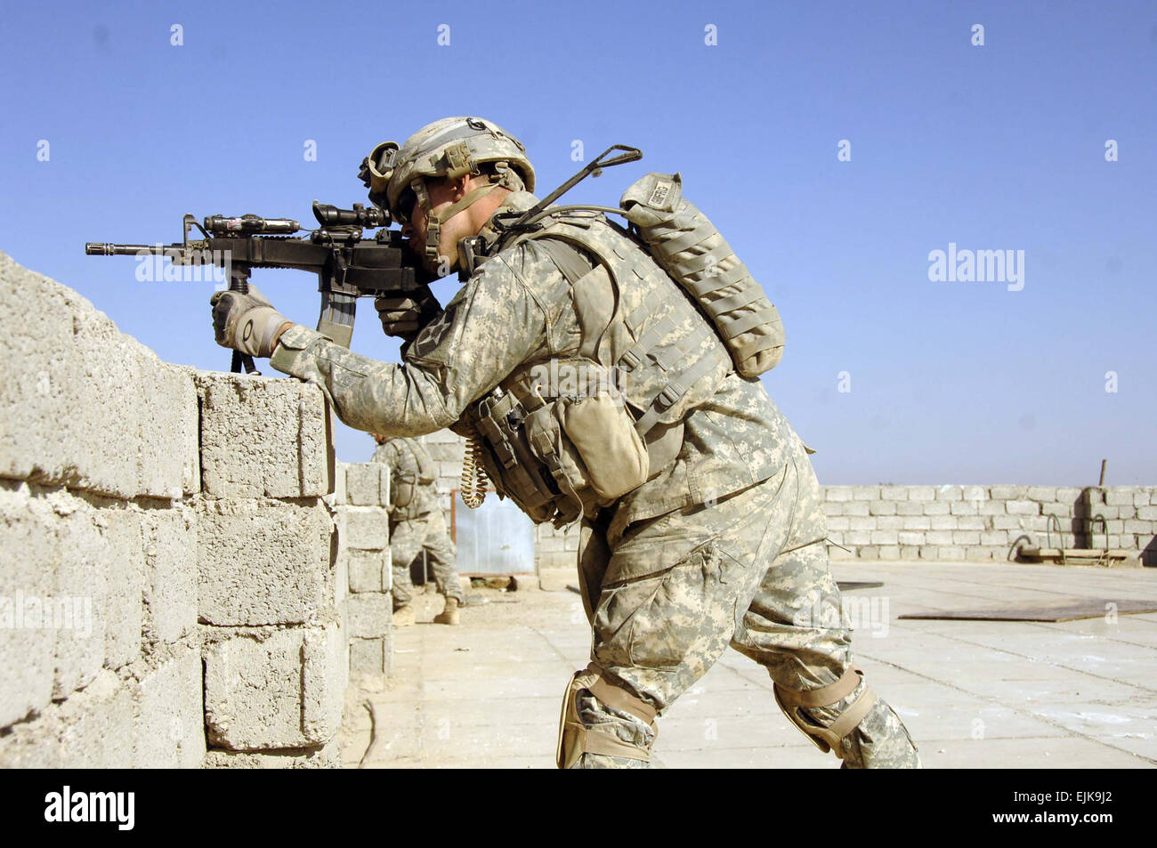 U.S. Army Staff Sgt. Michael Griffing provides security on the rooftop ...