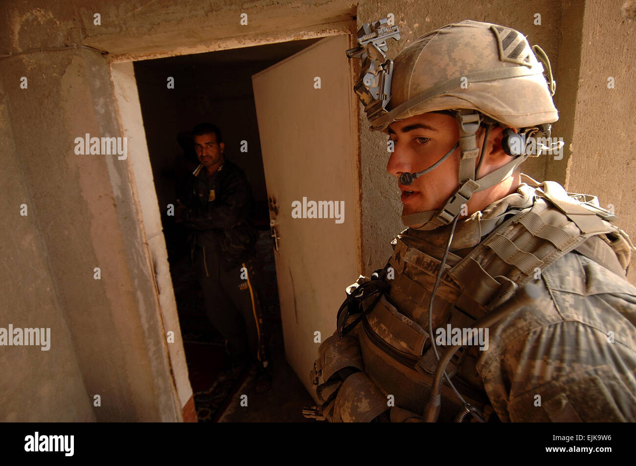 A local man looks out his front door as a U.S. Army Soldier from Bravo ...