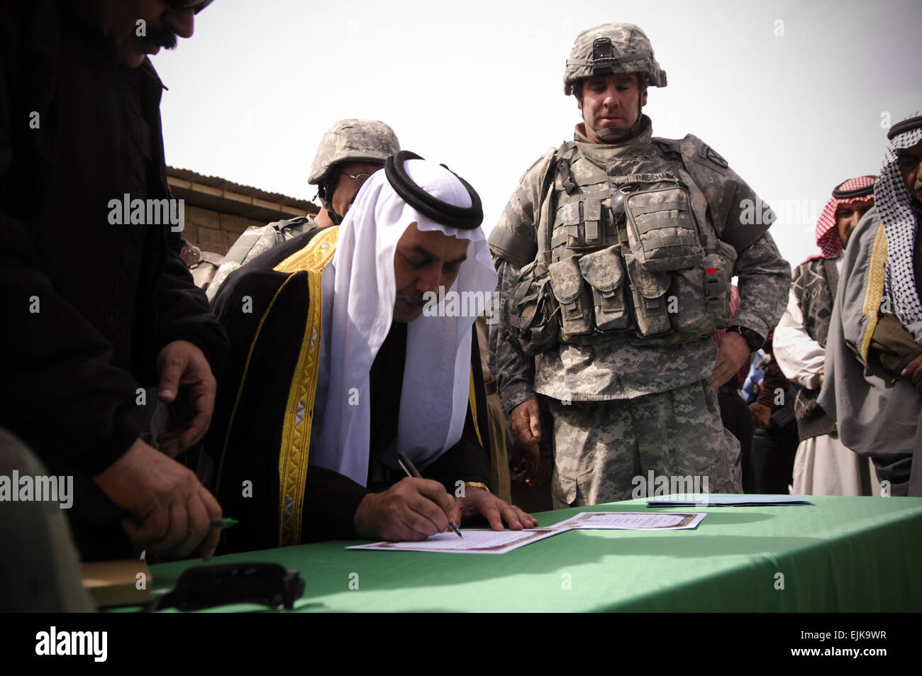 Sheik Abdullah Sami Obeidi, a Sunni Arab tribal leader, signs ...