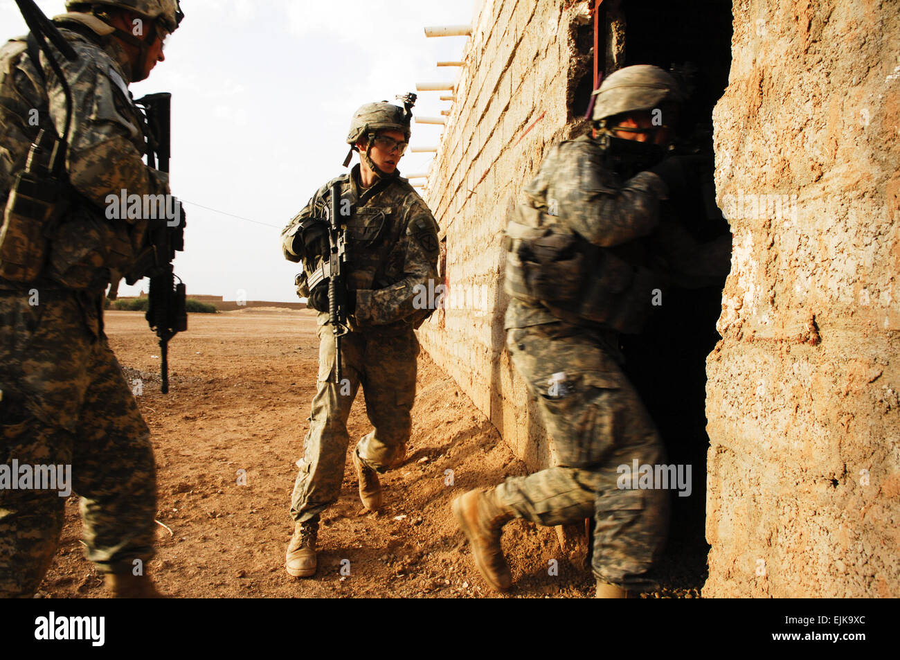 U.S. Army Soldiers rush through a door during a cordon and search ...