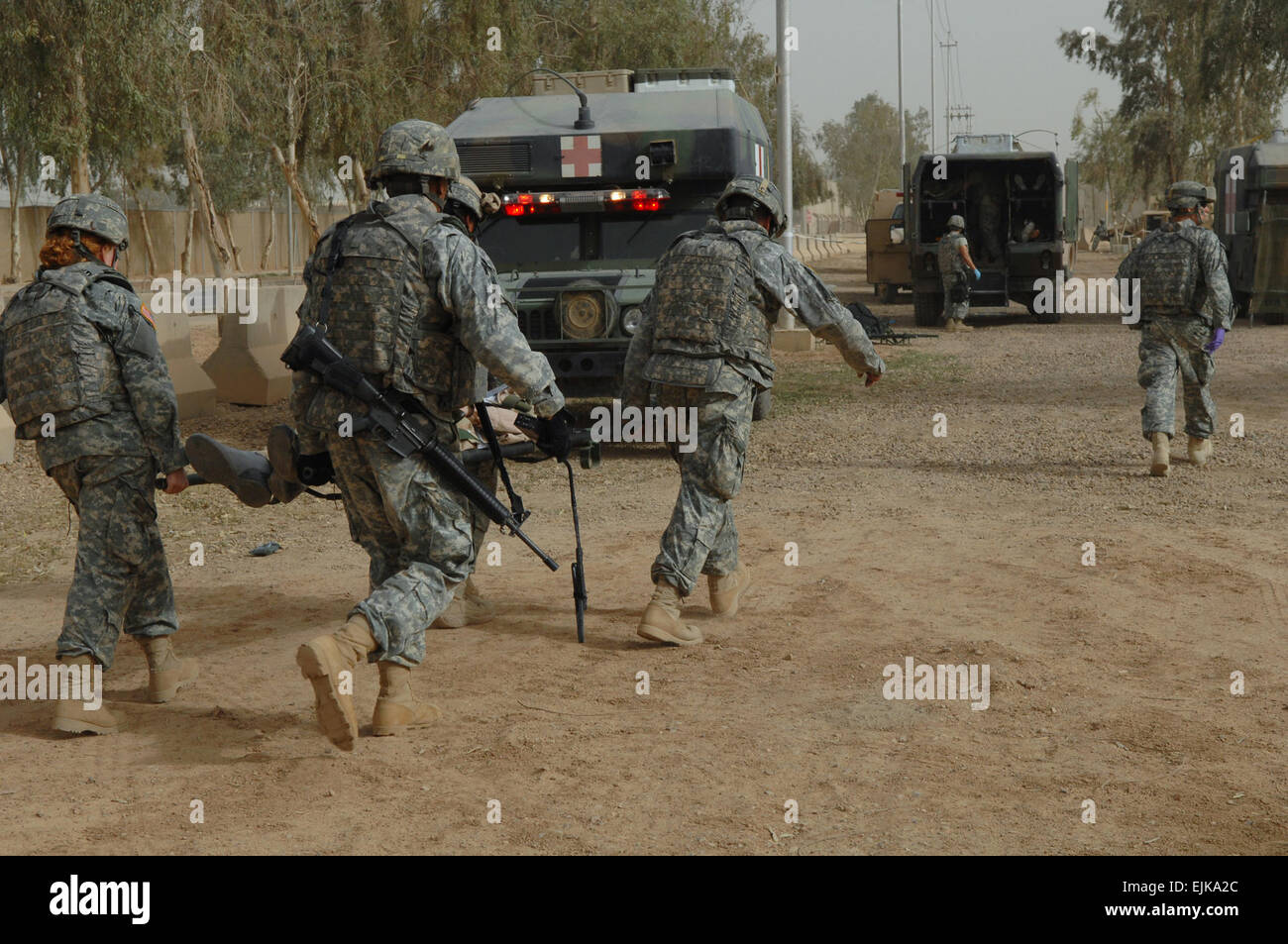 U.S. Army Soldiers carry a simulated casualty to an ambulance during a ...