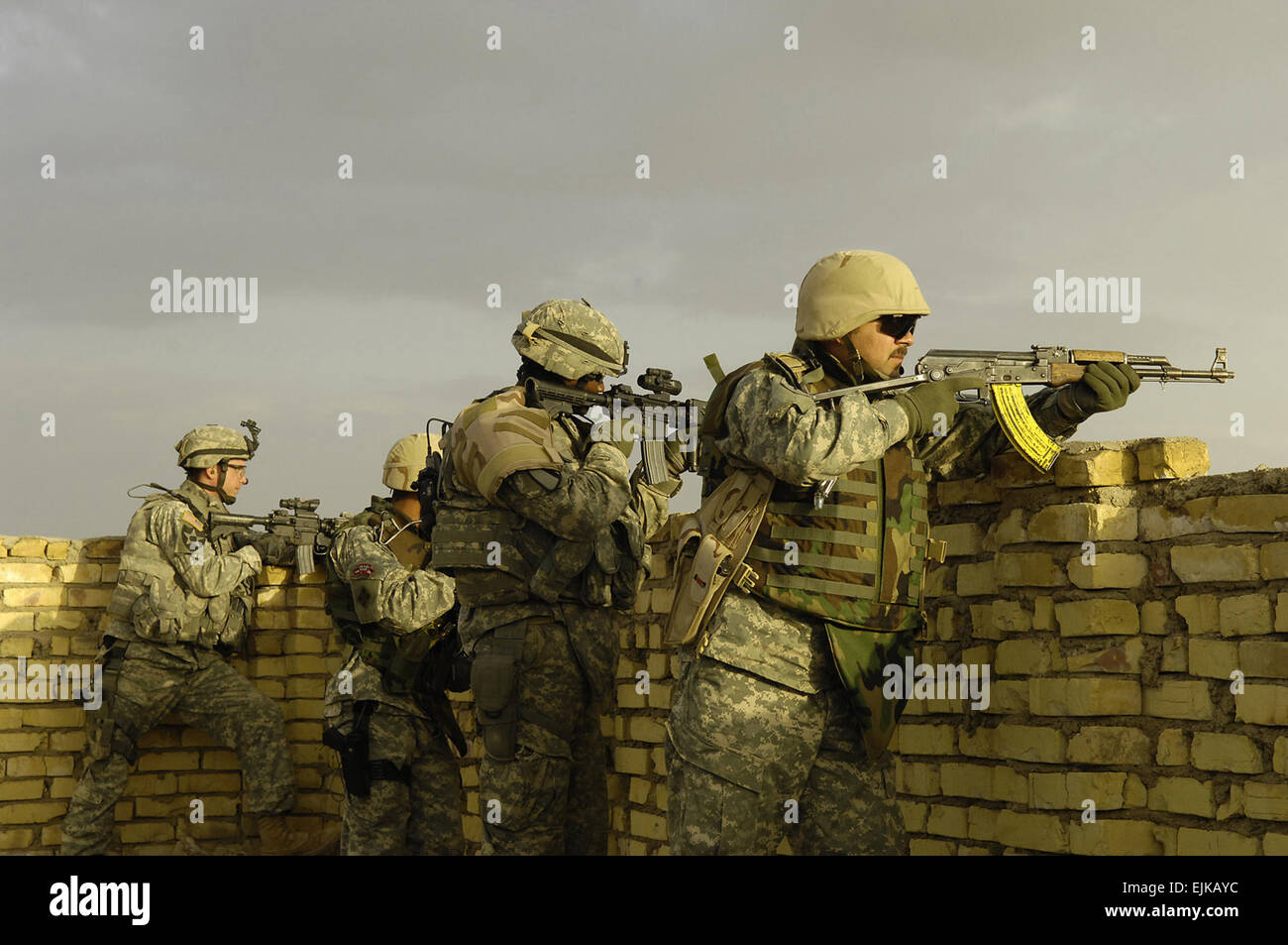 U.S. Army Soldiers with the Military Transition Team provide overhead ...