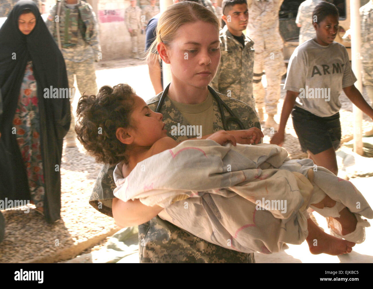 A U.S. Army soldier carries a wounded Iraqi child into the Charlie ...