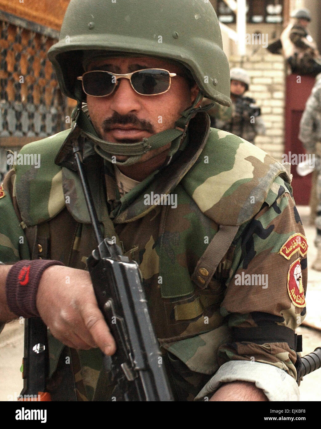 An Iraqi National policeman pulls security during a combined cordon and ...