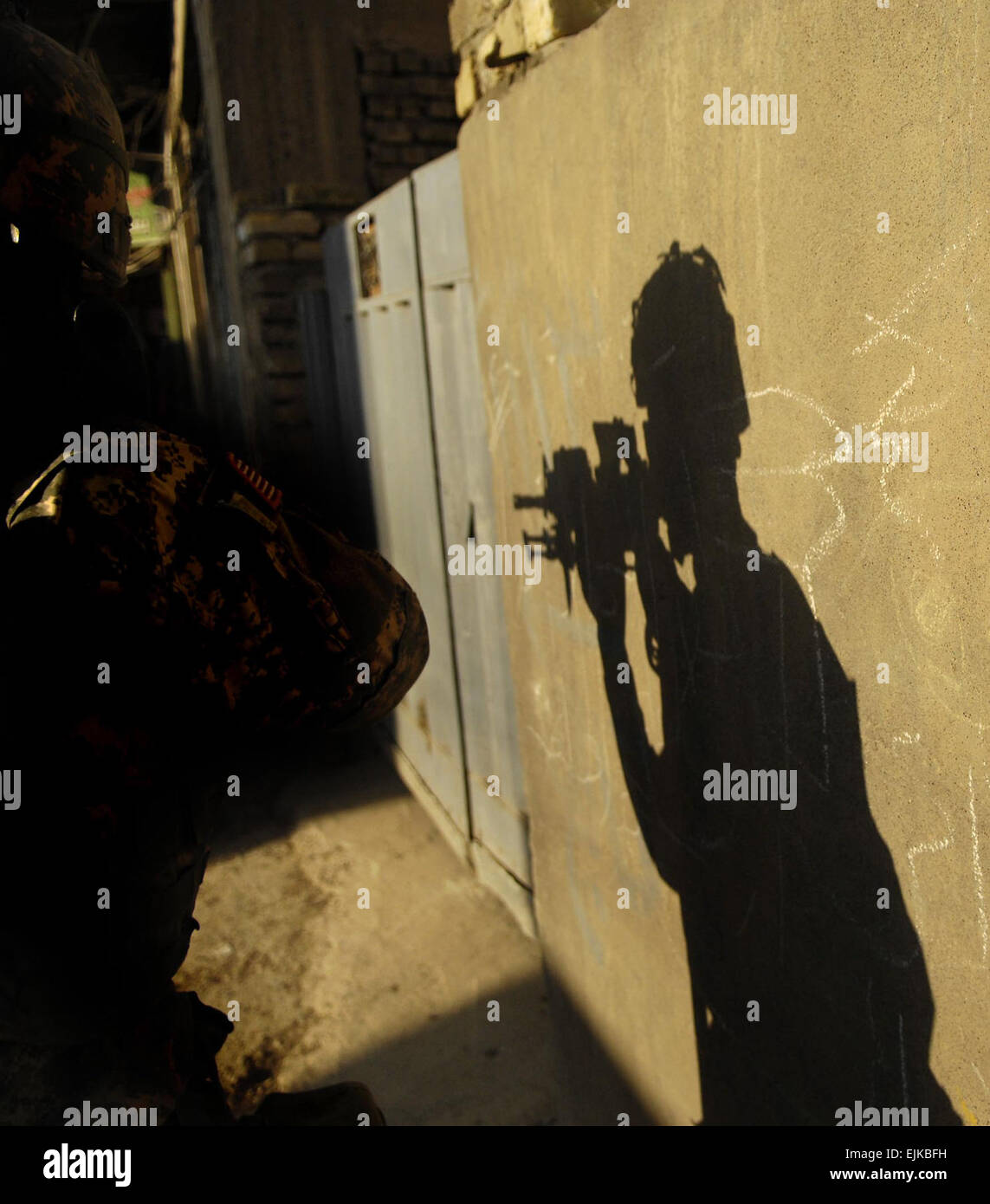 A U.S. Army Soldier uses his scope to investigate a suspicious vehicle ...