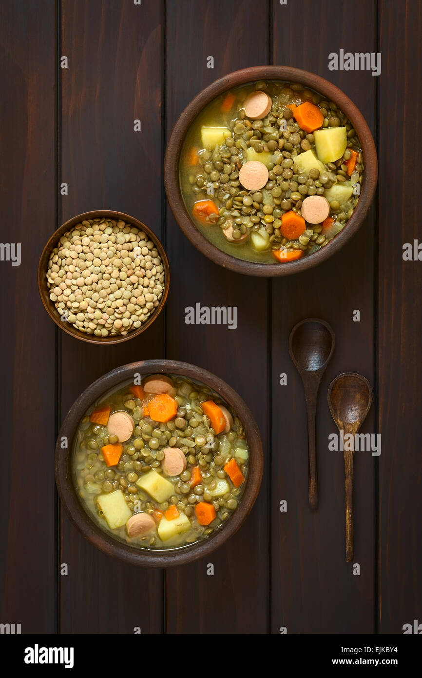 Overhead shot of two rustic bowls of lentil soup made with potato ...