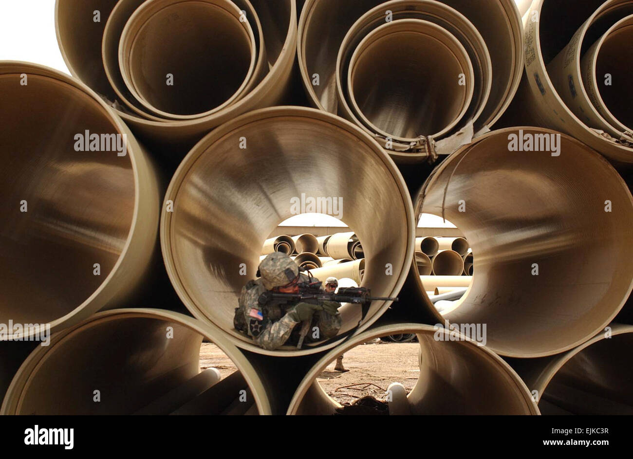 U.S. Army Staff Sgt. Larry Clapper checks the area for snipers while ...