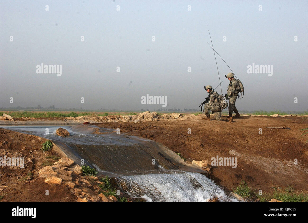 U.S. Army Soldiers stop to listen to a radio transmission during a ...