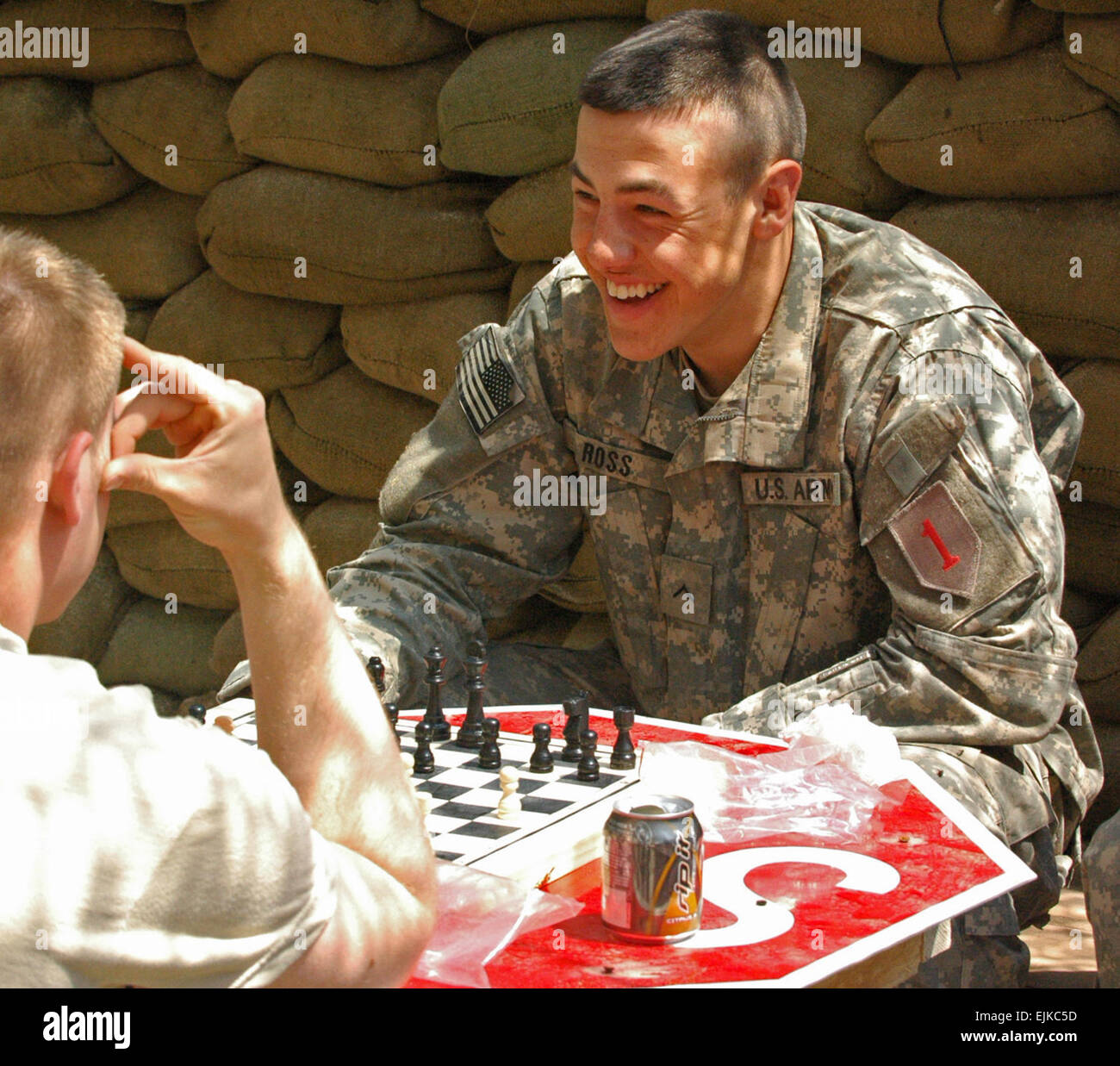 U.S. Army Pvt. Hershell Ross and Sgt. Cleveland Upton play a game of ...