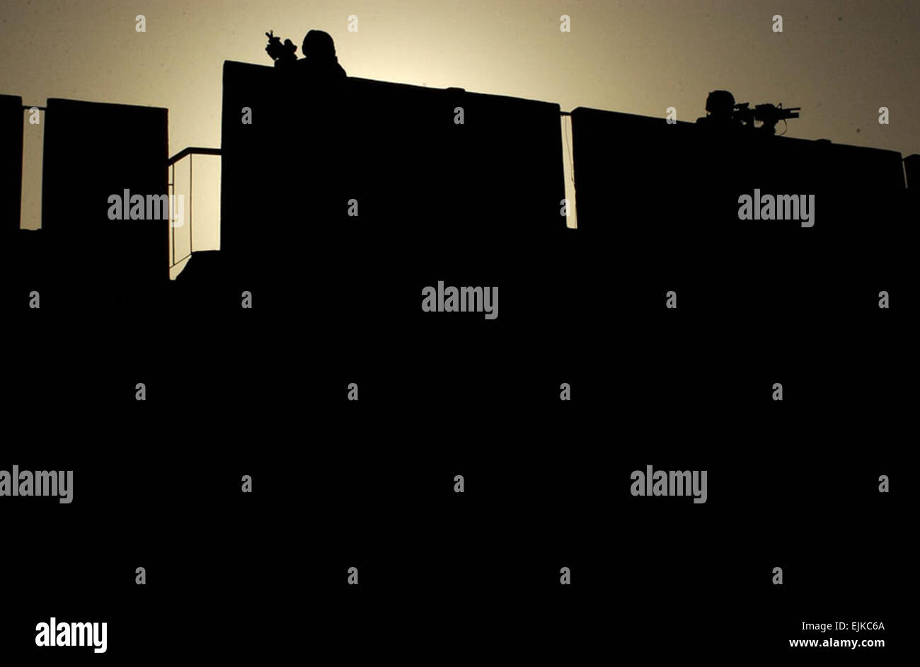 U.S. Army Soldiers pull security in an overwatch position on the roof ...