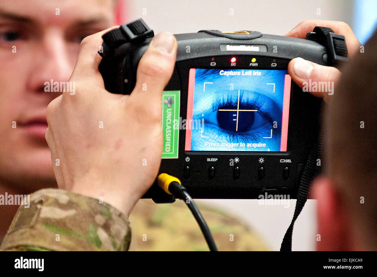 A paratrooper scans the iris of another using a Handheld Interagency ...
