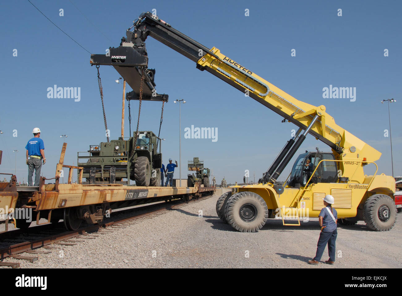 Rail yard workers load heavy equipment from 3rd Brigade Combat Team ...