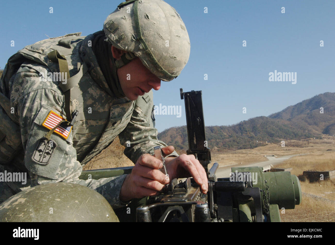 U.S. Army Spc. Ross Morrison sets up a .50-caliber machine gun on a ...