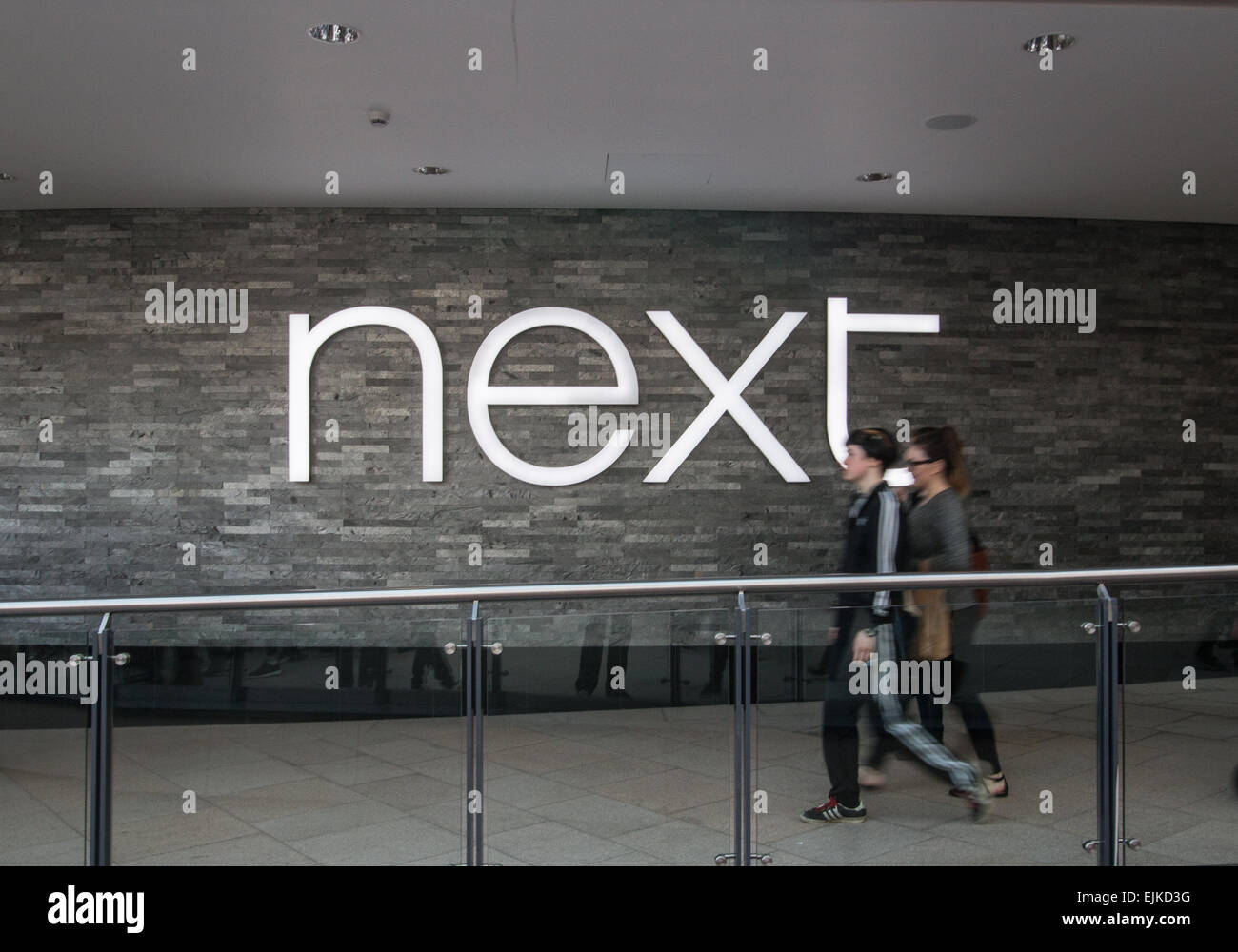 Next shop sign with shoppers in leeds Stock Photo - Alamy