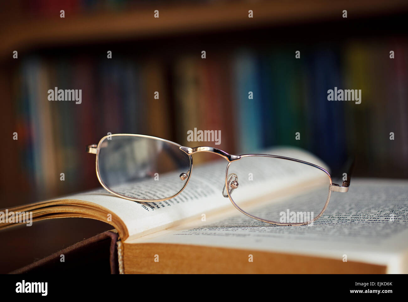 Glasses on a book Stock Photo - Alamy