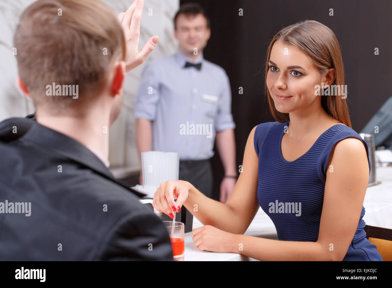 Man calls a waiter Stock Photo - Alamy