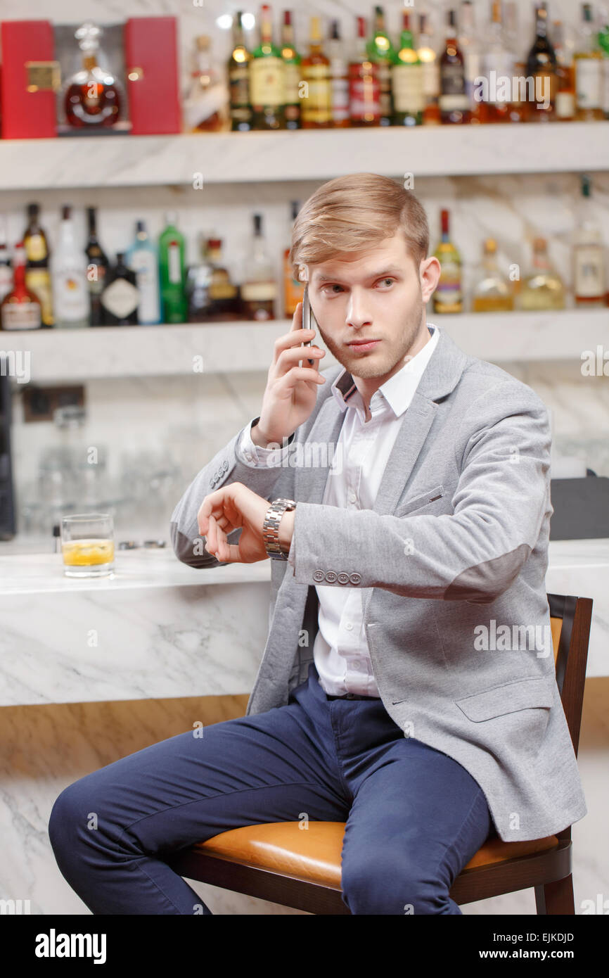 Waiting for friends in the bar Stock Photo - Alamy