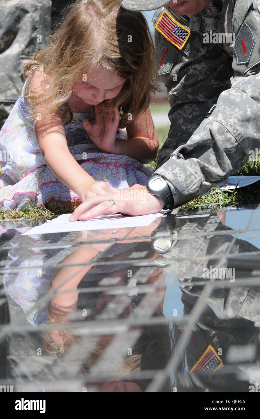 Hannah Maher makes a rubbing of the memorial stone honoring her dad ...