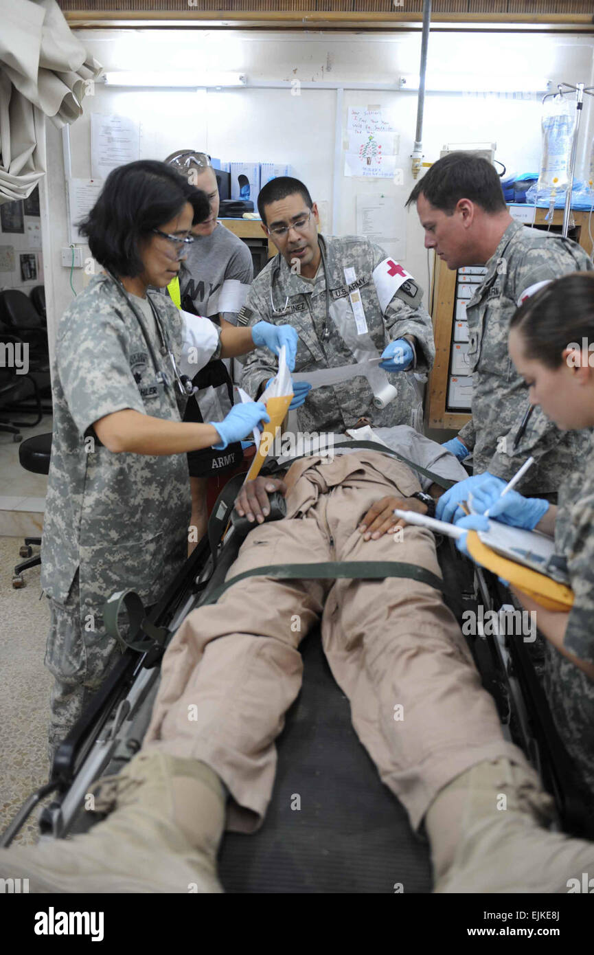 U.S. Army Lt. Col. Veronica Baechler attends to a simulated patient and ...