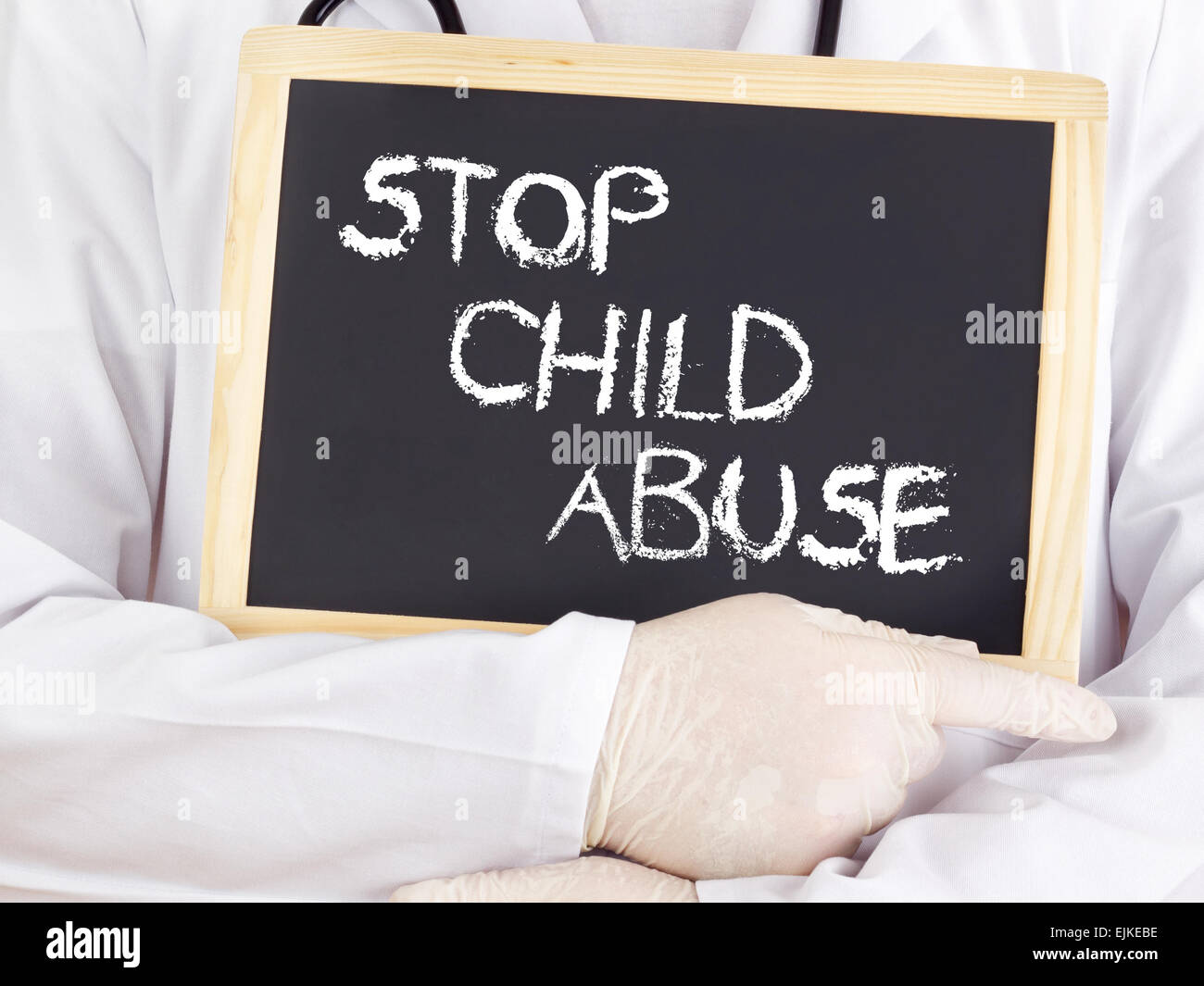 Doctor shows information: Stop Child Abuse Stock Photo - Alamy