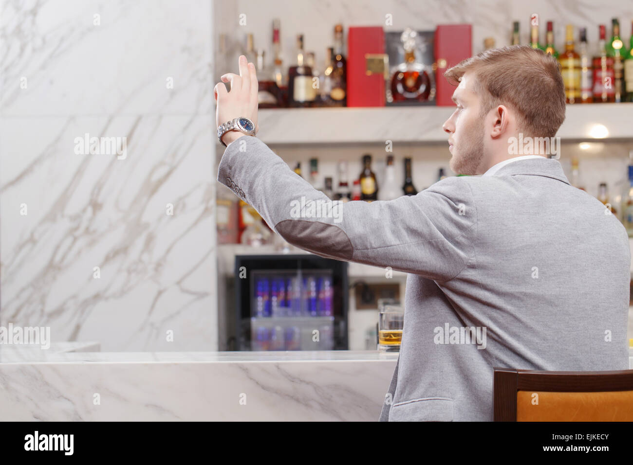 Man with a cocktail in the bar Stock Photo - Alamy