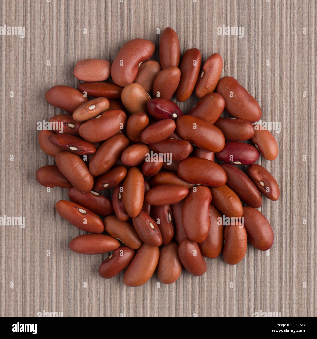 Circle of red beans on beige vinyl background Stock Photo - Alamy