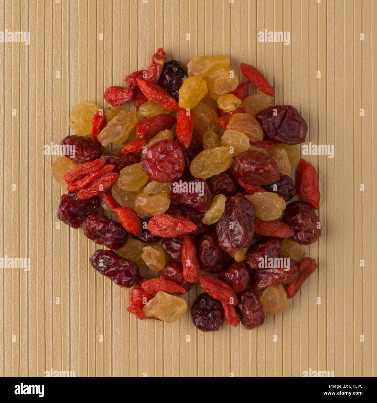 Top view of circle of mixed dried fruits against yellow vinyl ...