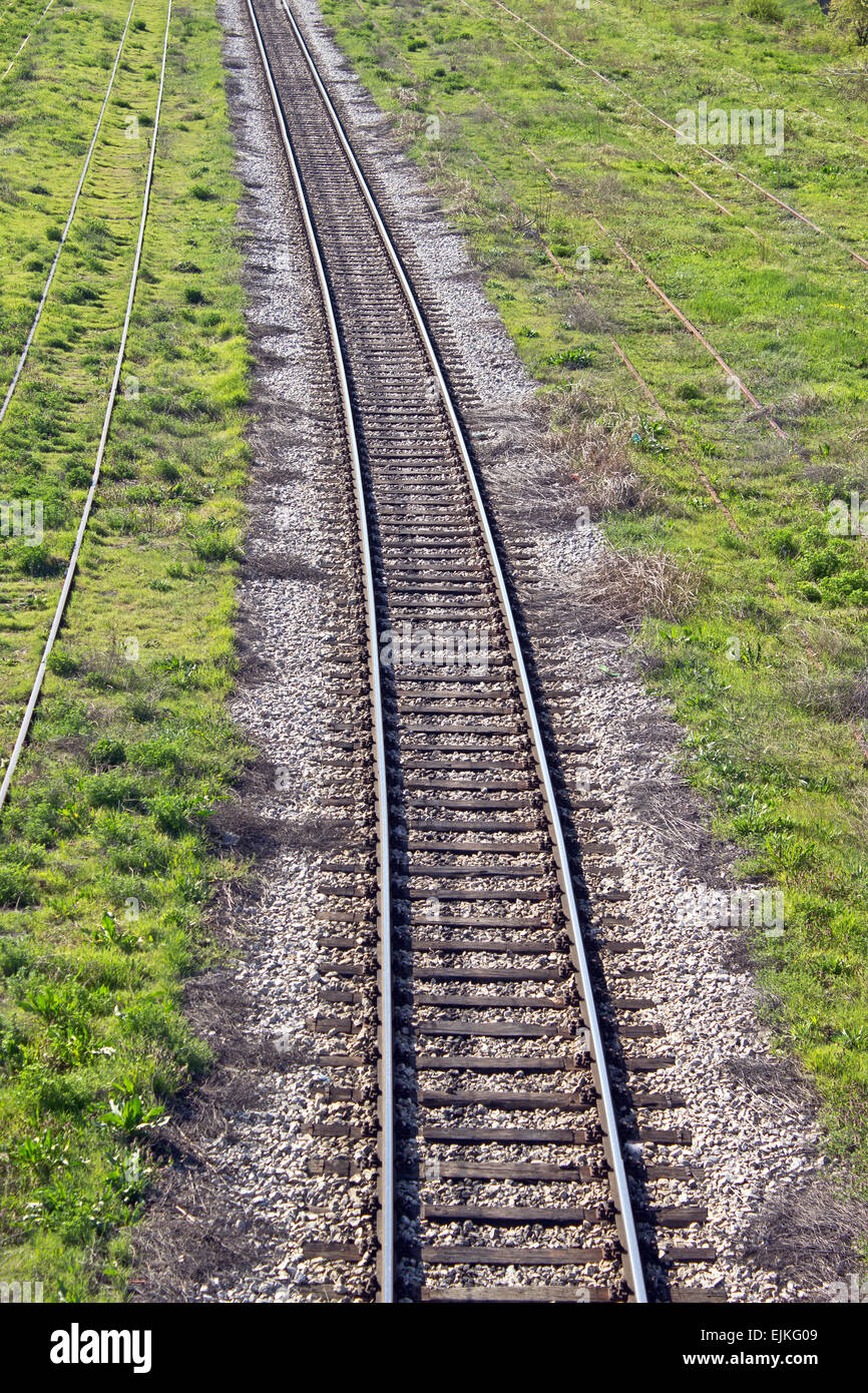 Railroad track through the landscape Stock Photo - Alamy