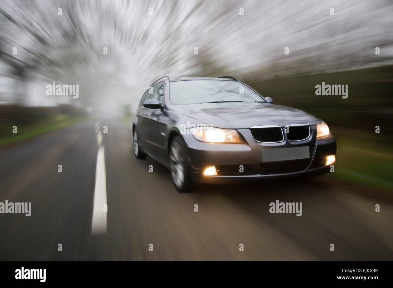 Car speeding along a country road Stock Photo - Alamy