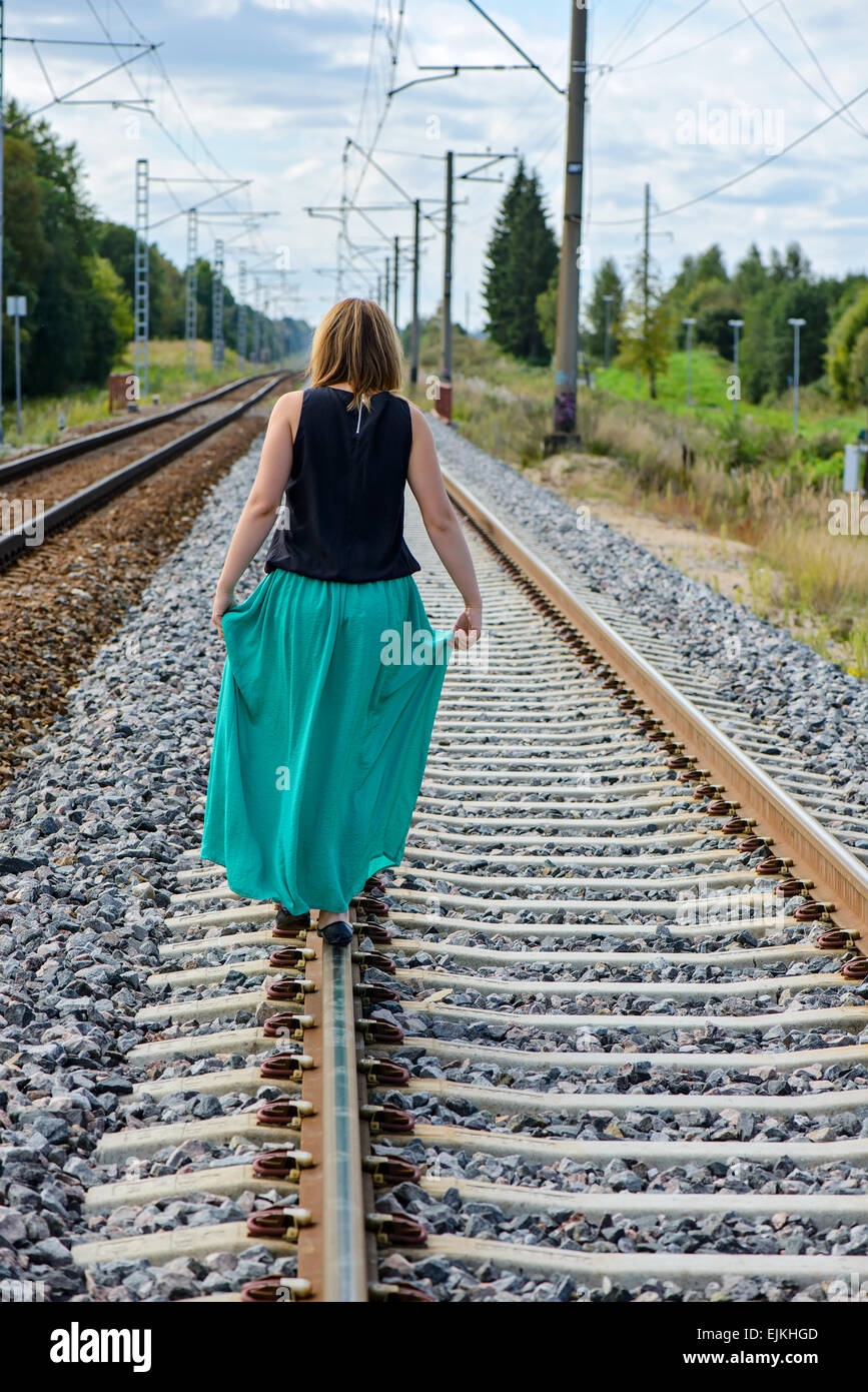 Young women walking on the rail track Stock Photo - Alamy
