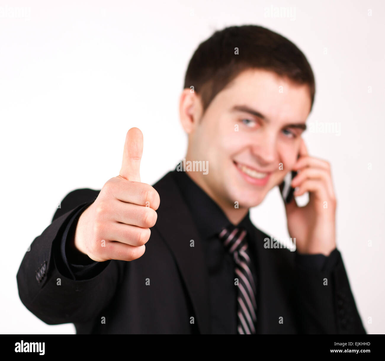 man talking on phone showing thumb Stock Photo - Alamy