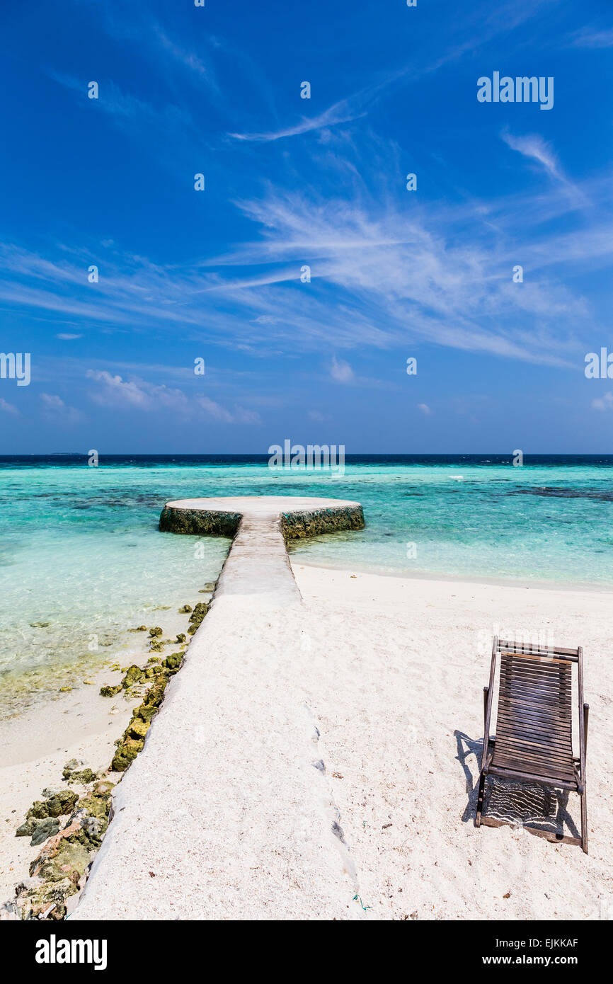A deck chair beside a sea defence groin at the island of Makunudu in ...