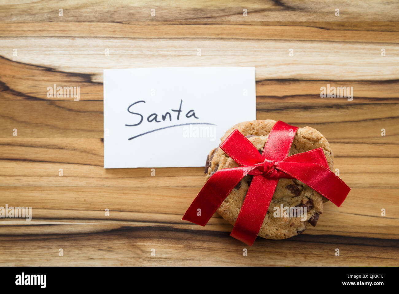 close up of a tack of cookies with a red ribbon and a note for Santa ...