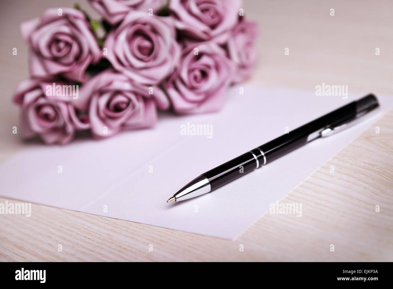pen and purple roses Stock Photo - Alamy