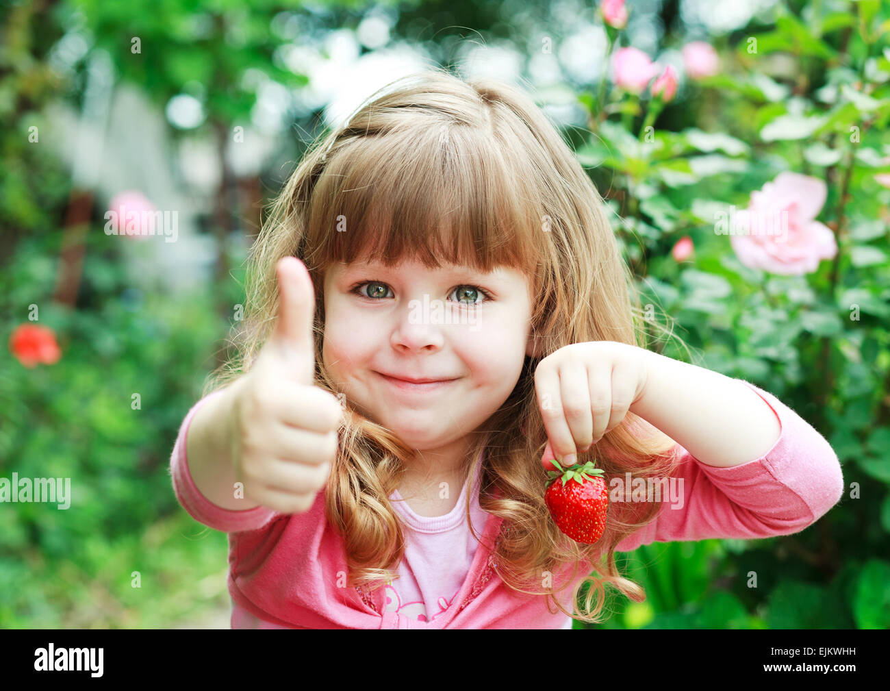 little girl with strawberry, say OK Stock Photo - Alamy