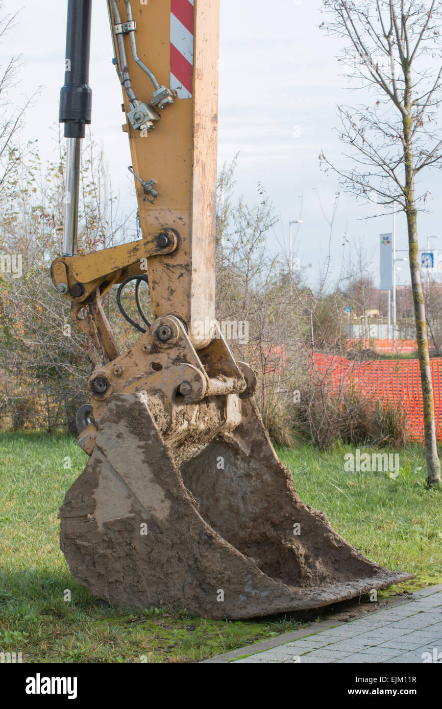 closeup of muddy excavator shovel on grass near building site Stock ...